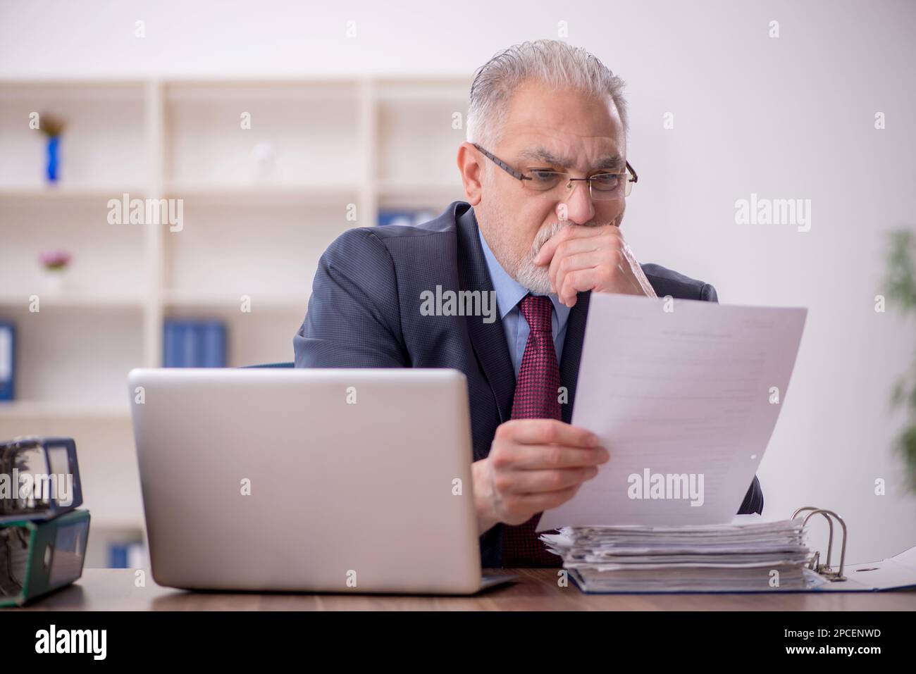 Old boss employee working at workplace Stock Photo - Alamy