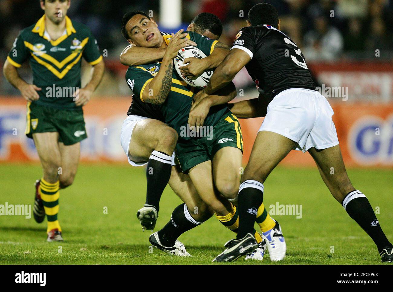 Australia's Reni Maitua is tackled by Kiwi's David Kidwell and Iosia ...