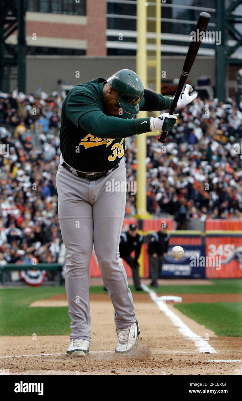Oakland Athletics Frank Thomas attempts to dodge a wild pitch by ...
