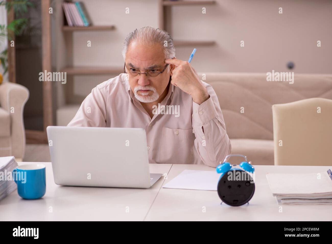Old boss employee working from home during pandemic Stock Photo - Alamy