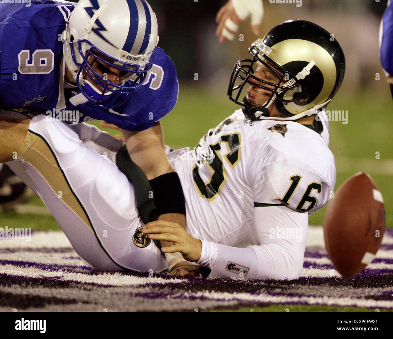 Colorado State quarterback Caleb Hanie, right, fumbles the football as ...