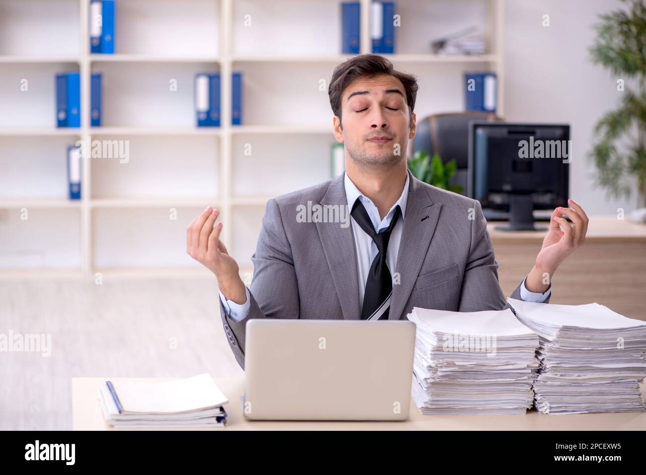Young businessman employee and too much work in the office Stock Photo ...