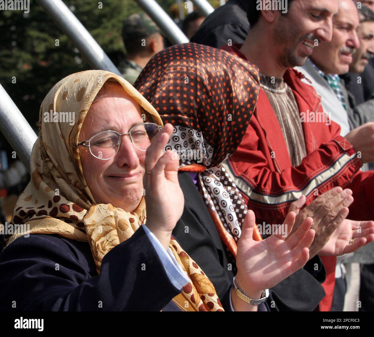Mothers and relatives cheer and cry as Turkish troops march during a ...