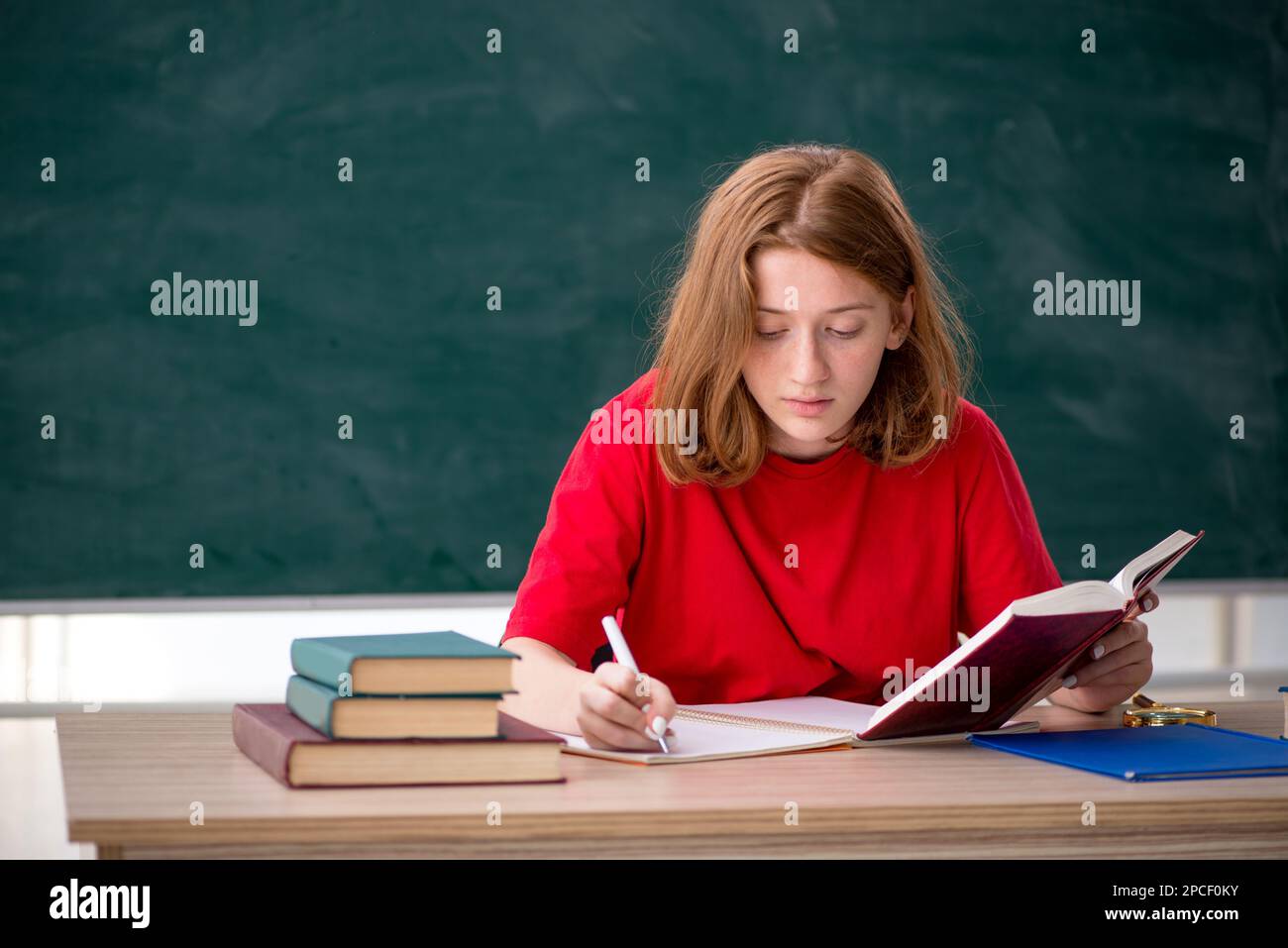 Female student preparing for exams in the classroom Stock Photo - Alamy