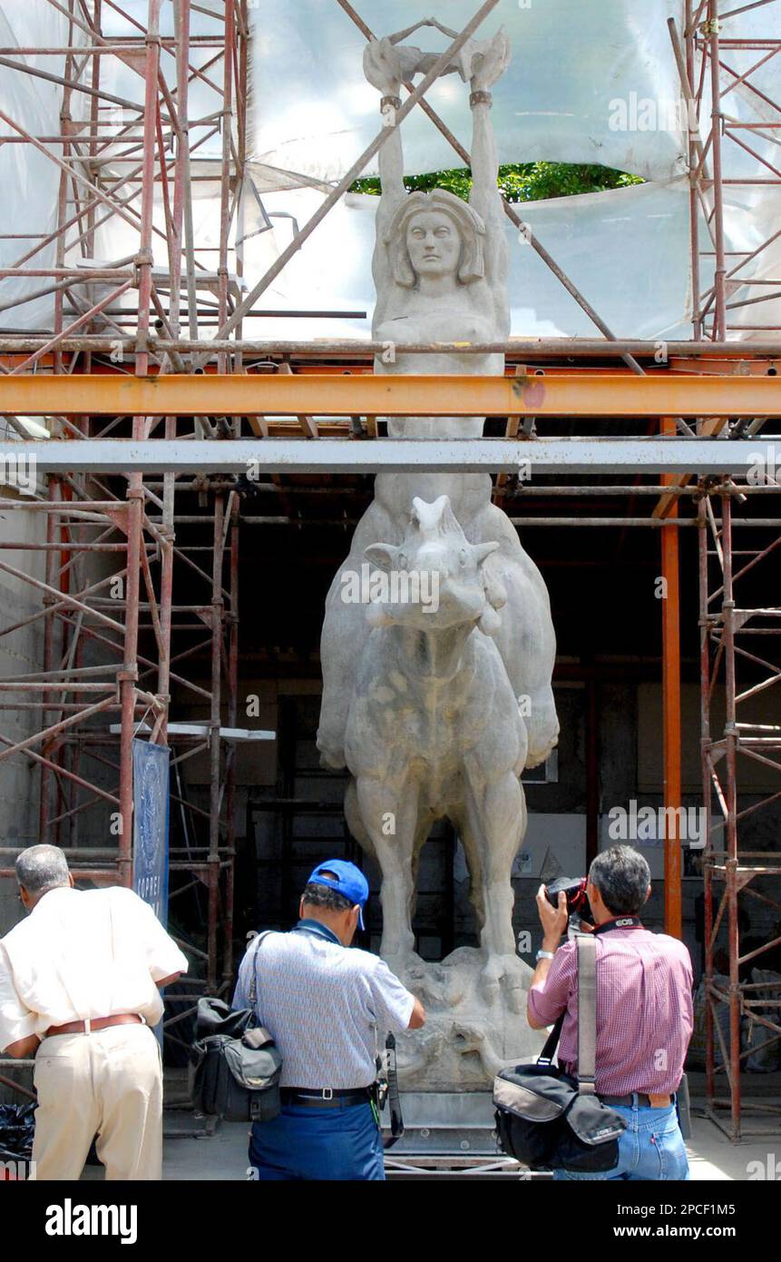 People take photographs of a statue of Venezuelan goddess Maria Lionza ...