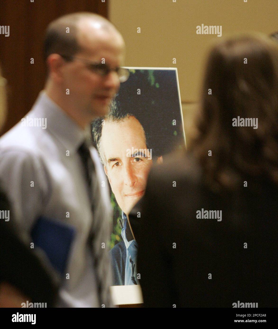 A large photo of slain federal prosecutor Thomas C. Wales is seen ...