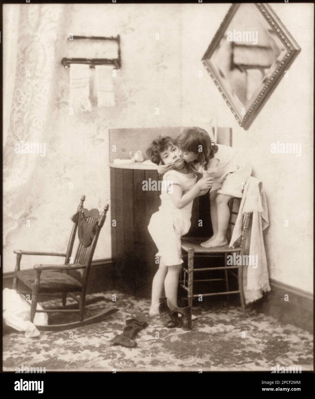 1893 , USA : " Scott children" . Small girl standing on a chair by wash ...