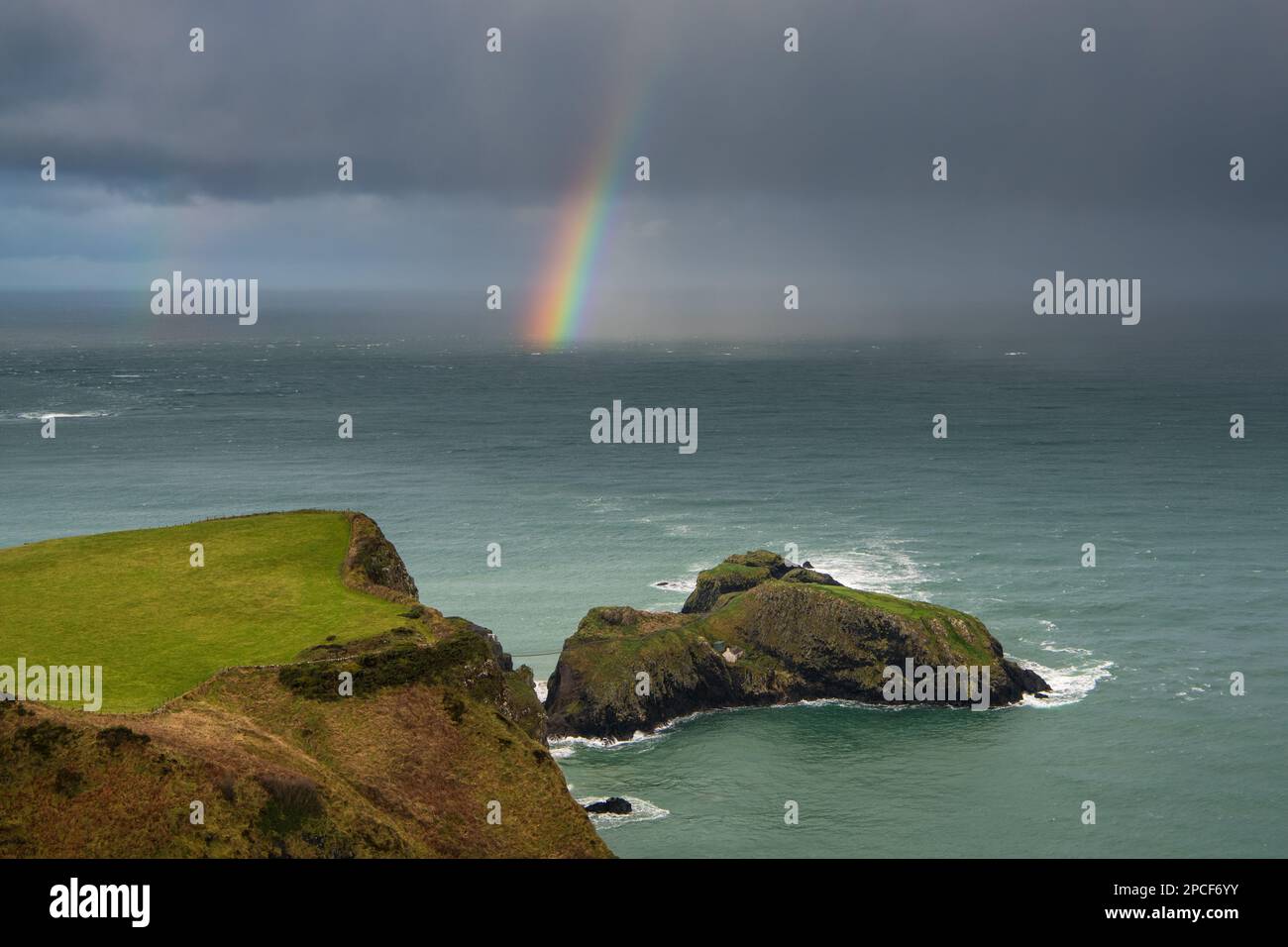 Rainbow and stormy sky above sea and headlands overlooking Carrick-a ...