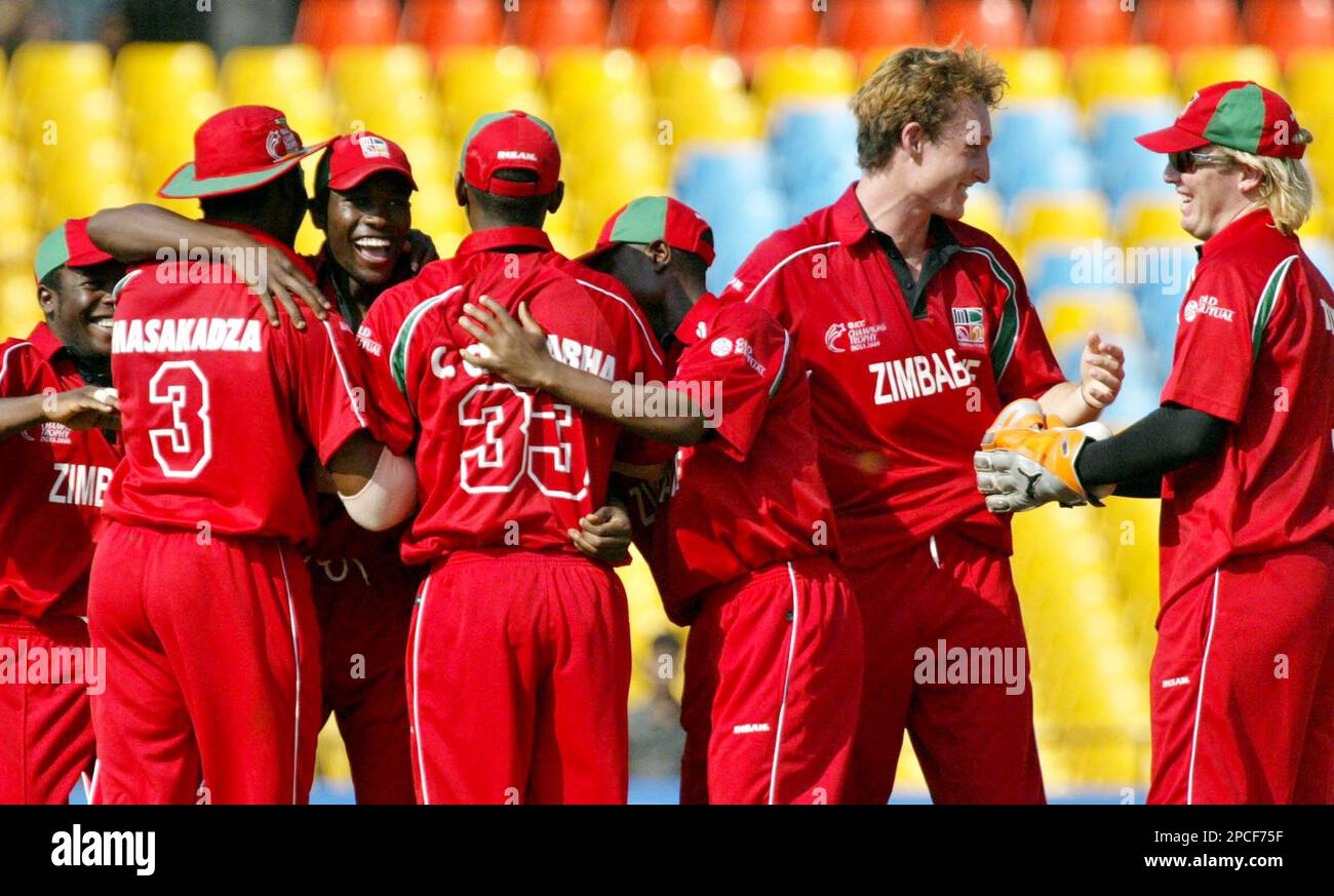 Zimbabwe cricketer Elton Chigumbura, third left, celebrates the ...