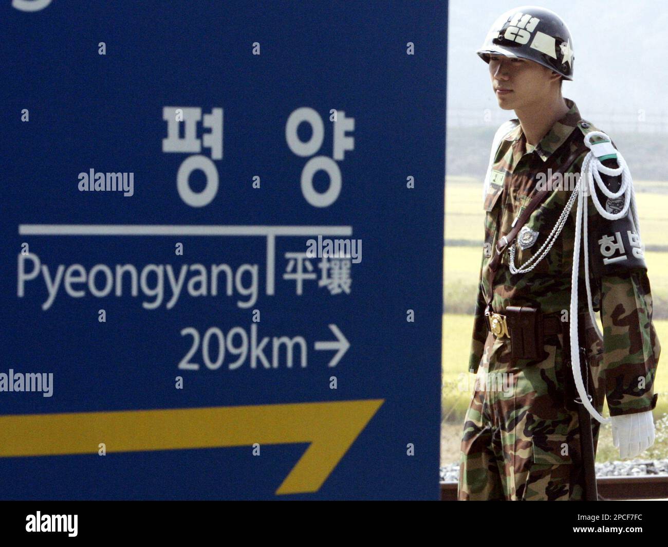 A South Korean military police walks past a signboard showing the ...