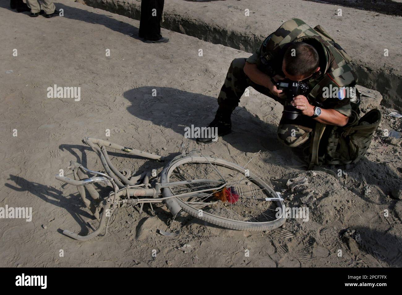 A French soldier takes pictures of the bicycle used in a bomb attack ...