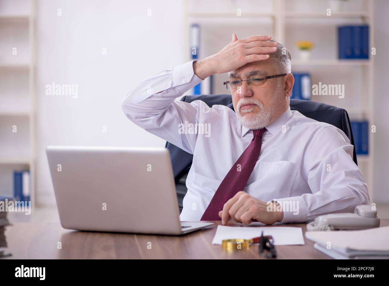 Old male employee feeling bad at workplace Stock Photo - Alamy