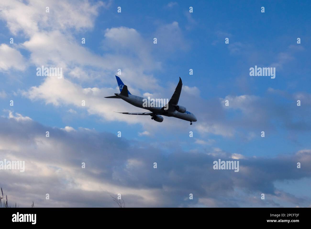 Commercial aircraft overflying the sky and arriving at airport Stock ...
