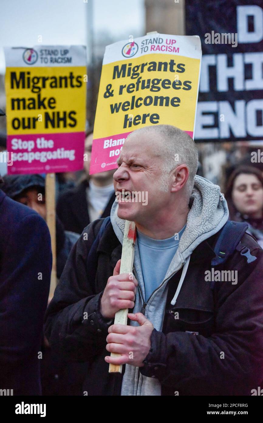 London, UK. 13th Mar, 2023. A protester holds a placard reading ...