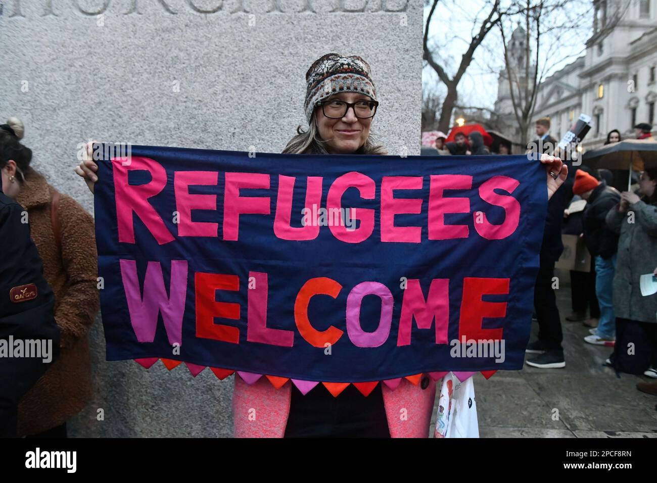 London, UK. 13th Mar, 2023. A protester holds a banner reading ...