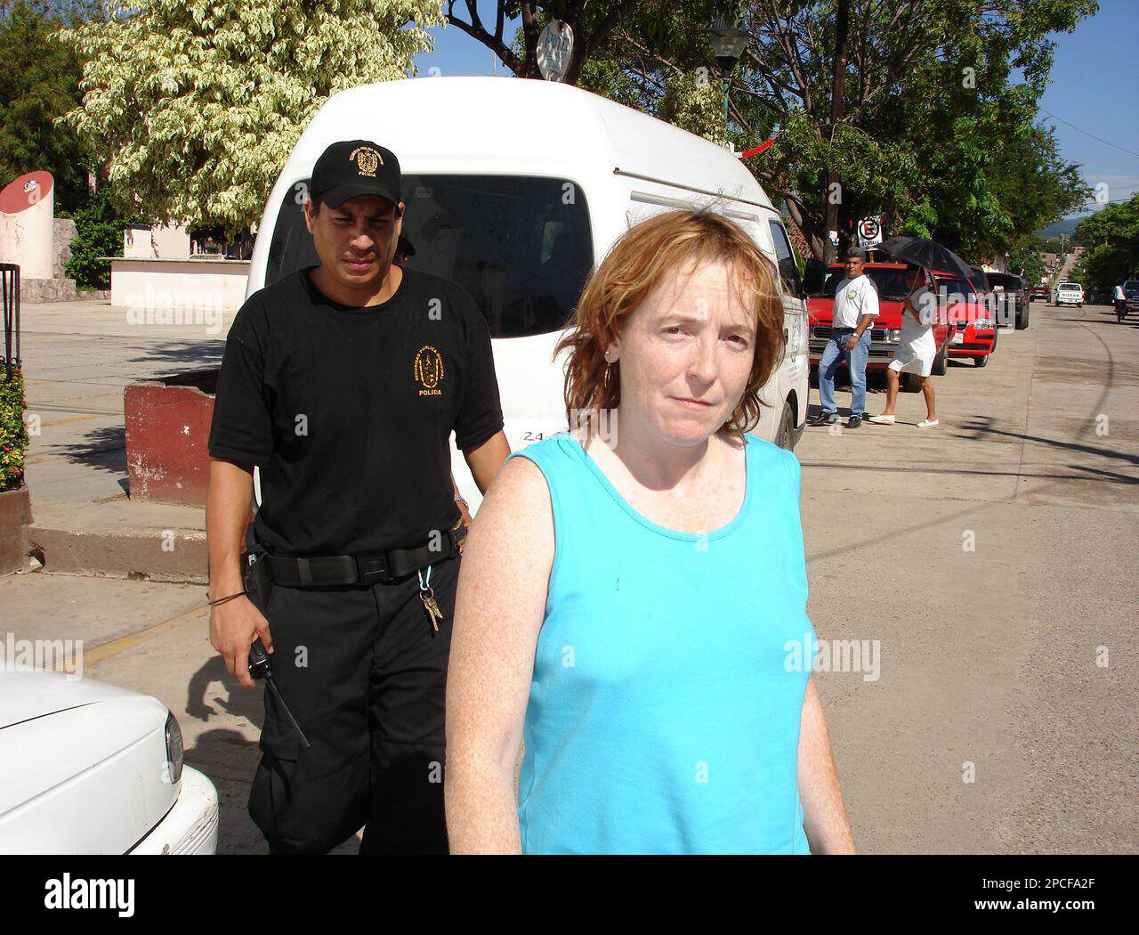 Tammy May Griffin, 46, of Anchorage, Alaska, front walks with a police ...