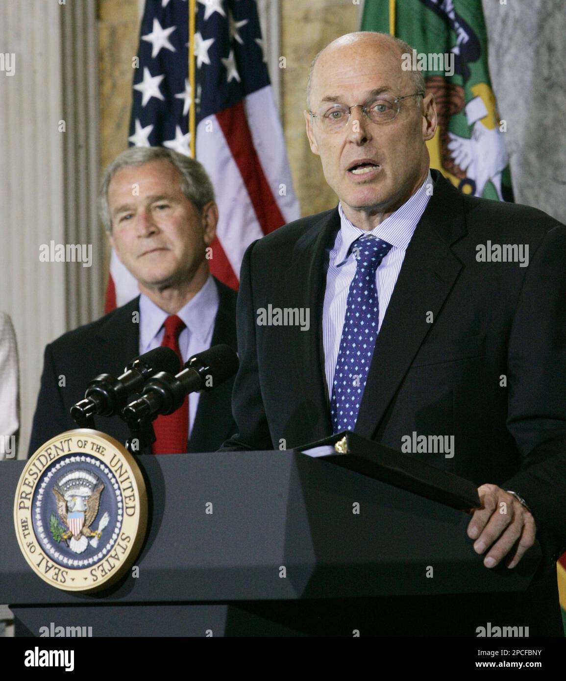 FILE *** President Bush, left, stands behind Treasury Secretary Henry ...