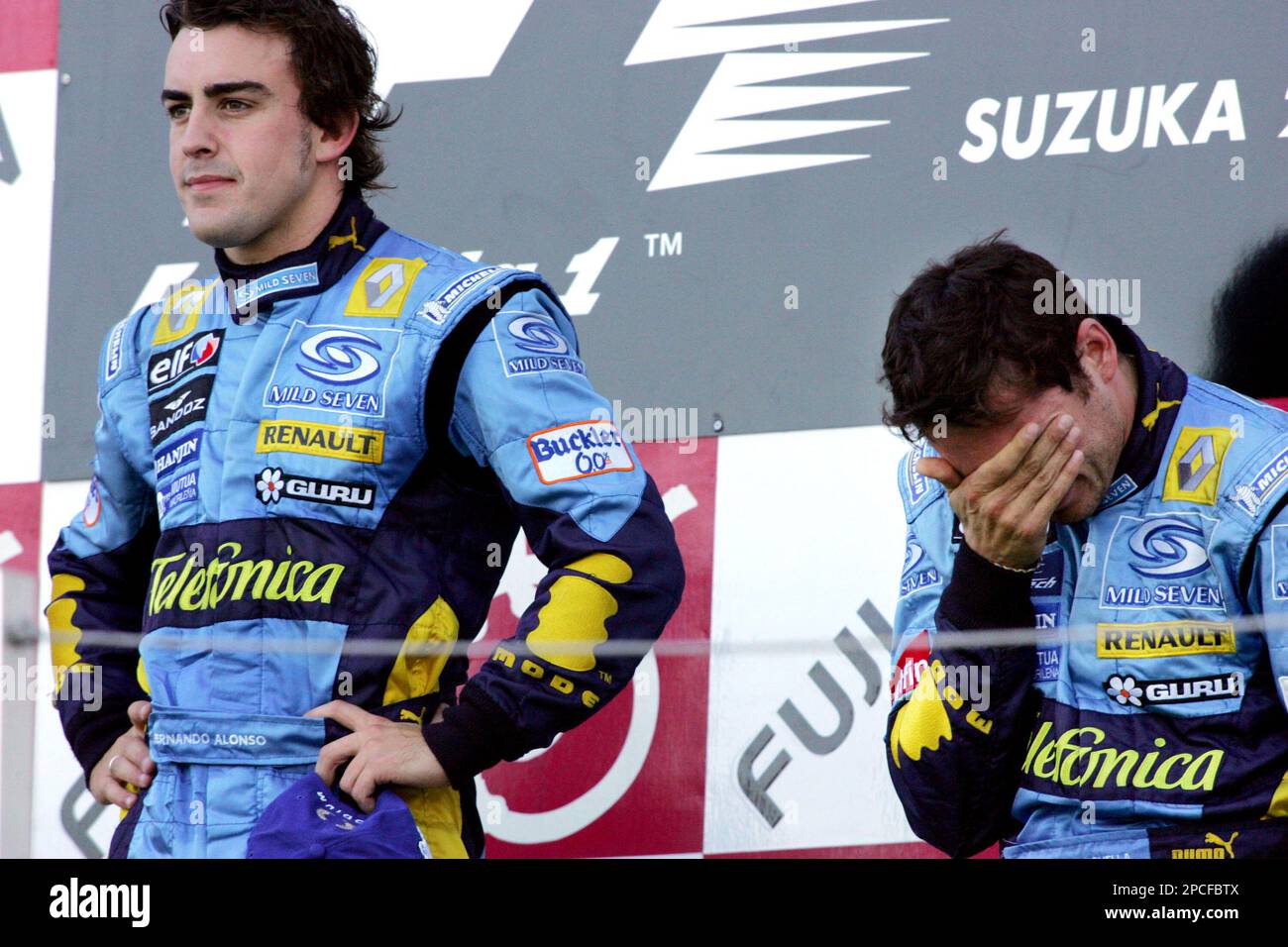 Reigning world champion Renault driver Fernando Alonso, left, of Spain poses as teammate Italian ...