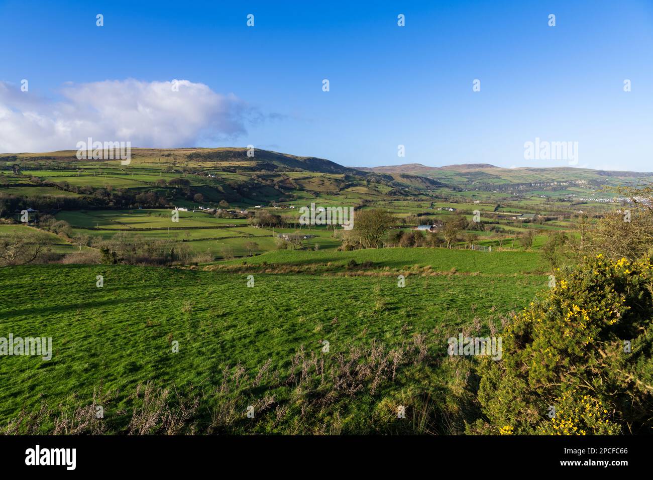 Idyllic rural landscape of green fields and rolling hills in Glencloy ...