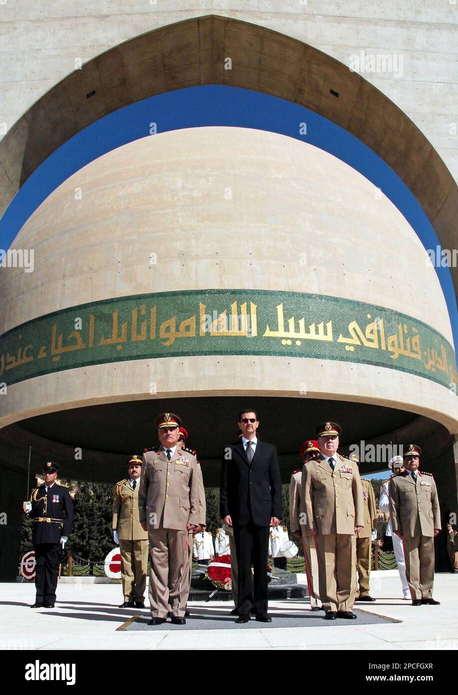 Syrian President Bashar Assad, center, Syrian Defense Minister Maj. Gen ...