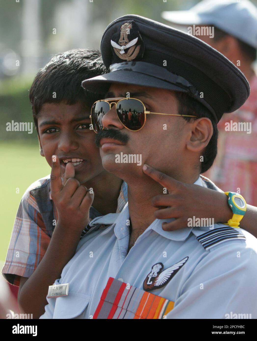 An Indian Air Force (IAF) soldier and his son watch aerobatics ...