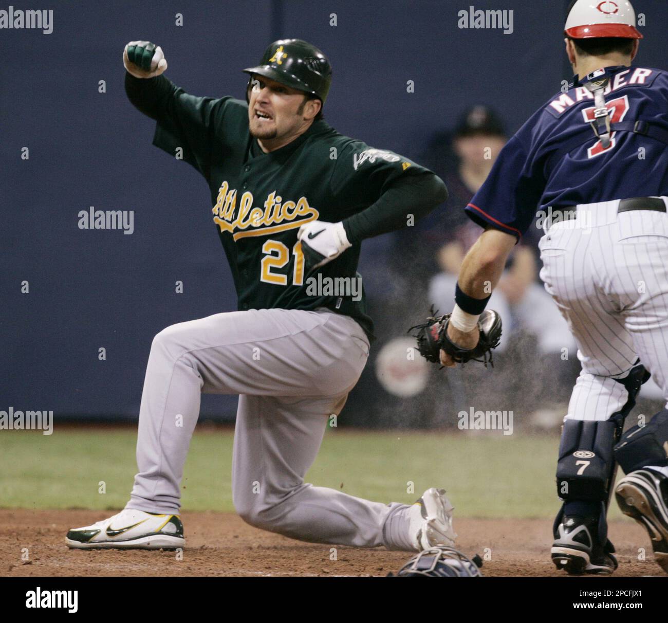 Oakland's Mark Kotsay slides in for a two-run, inside-the-park homer ...