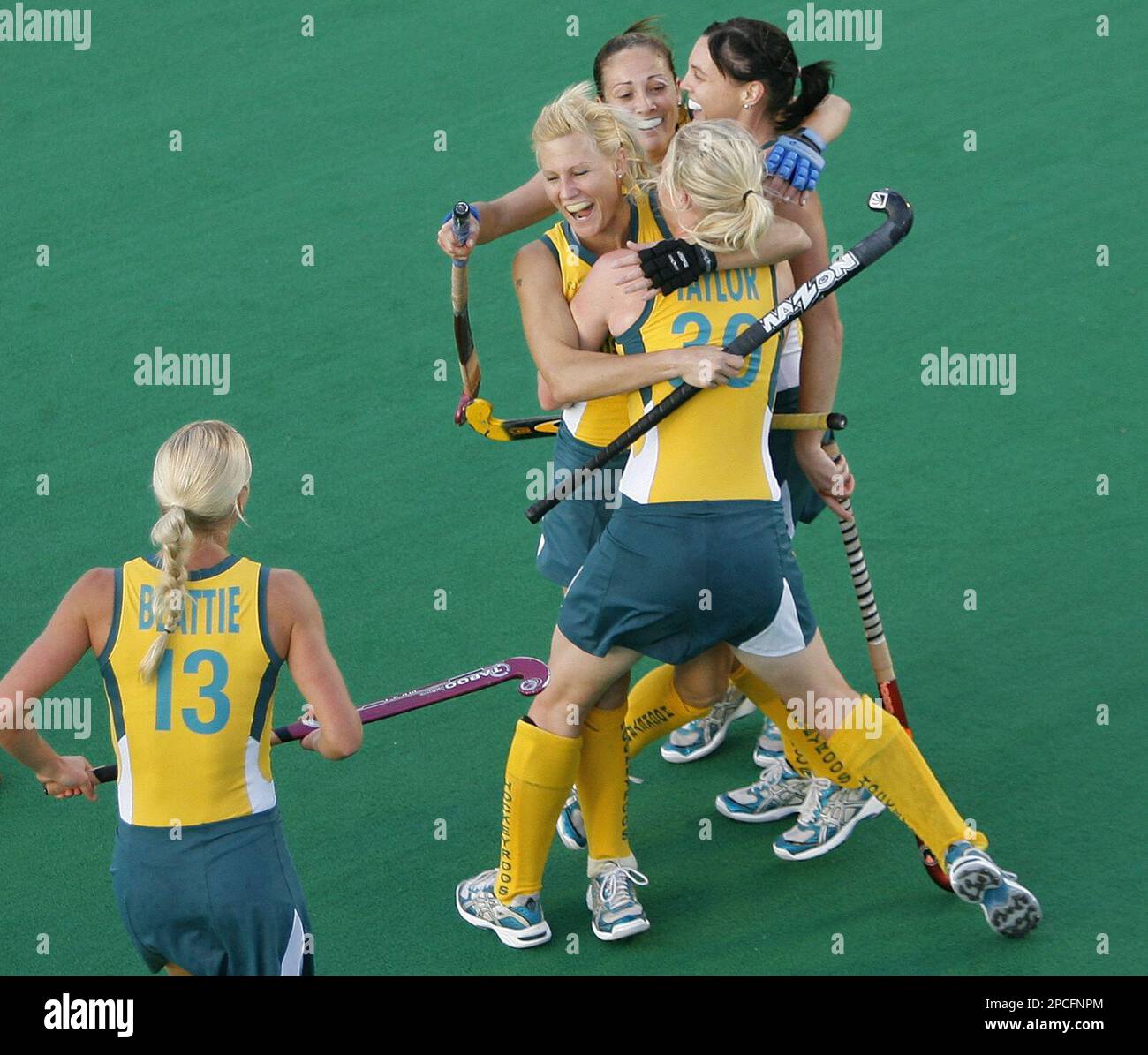 Australian player Wendy Beattie, left, run to celebrate with her team ...