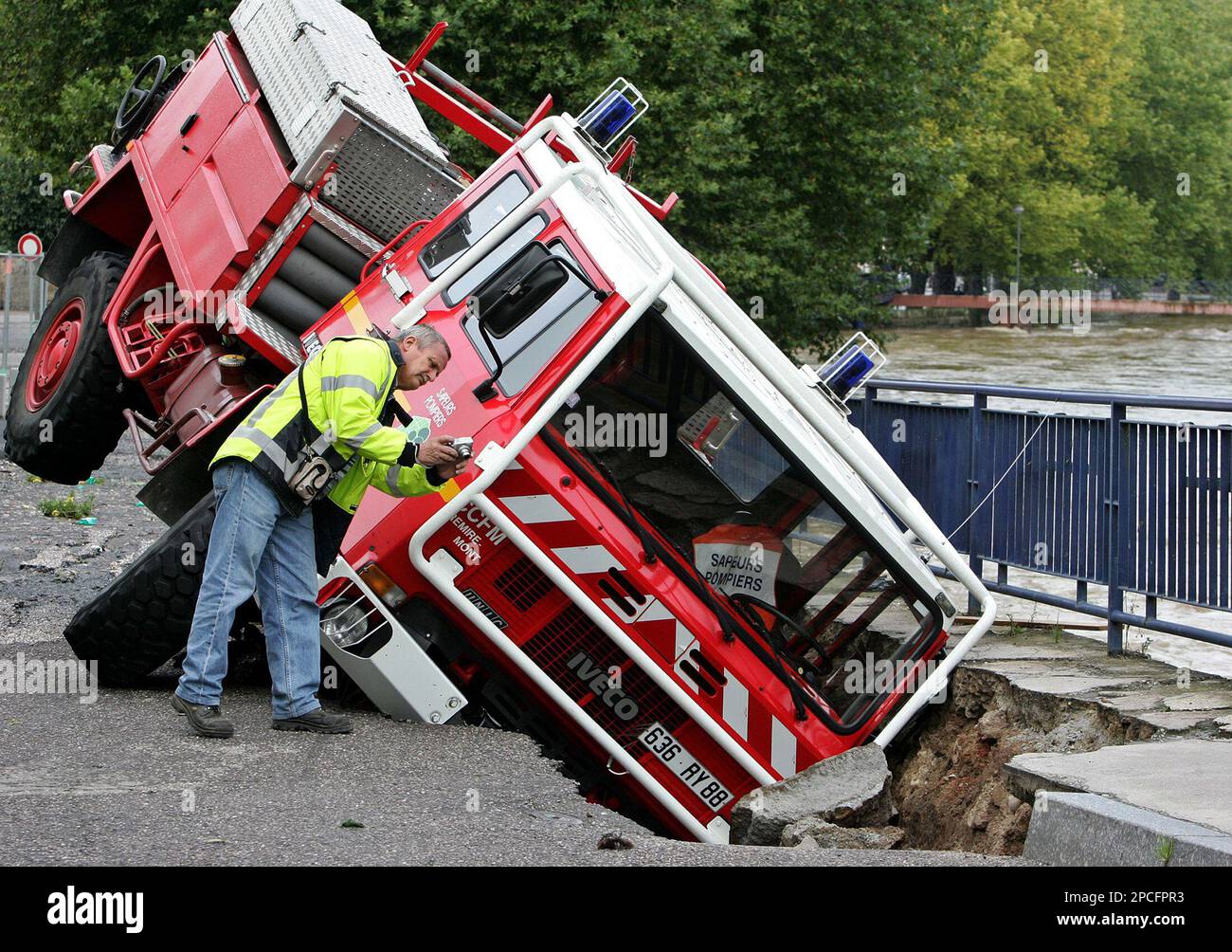 An employee of the municipality of Ramberviller takes pictures of a ...
