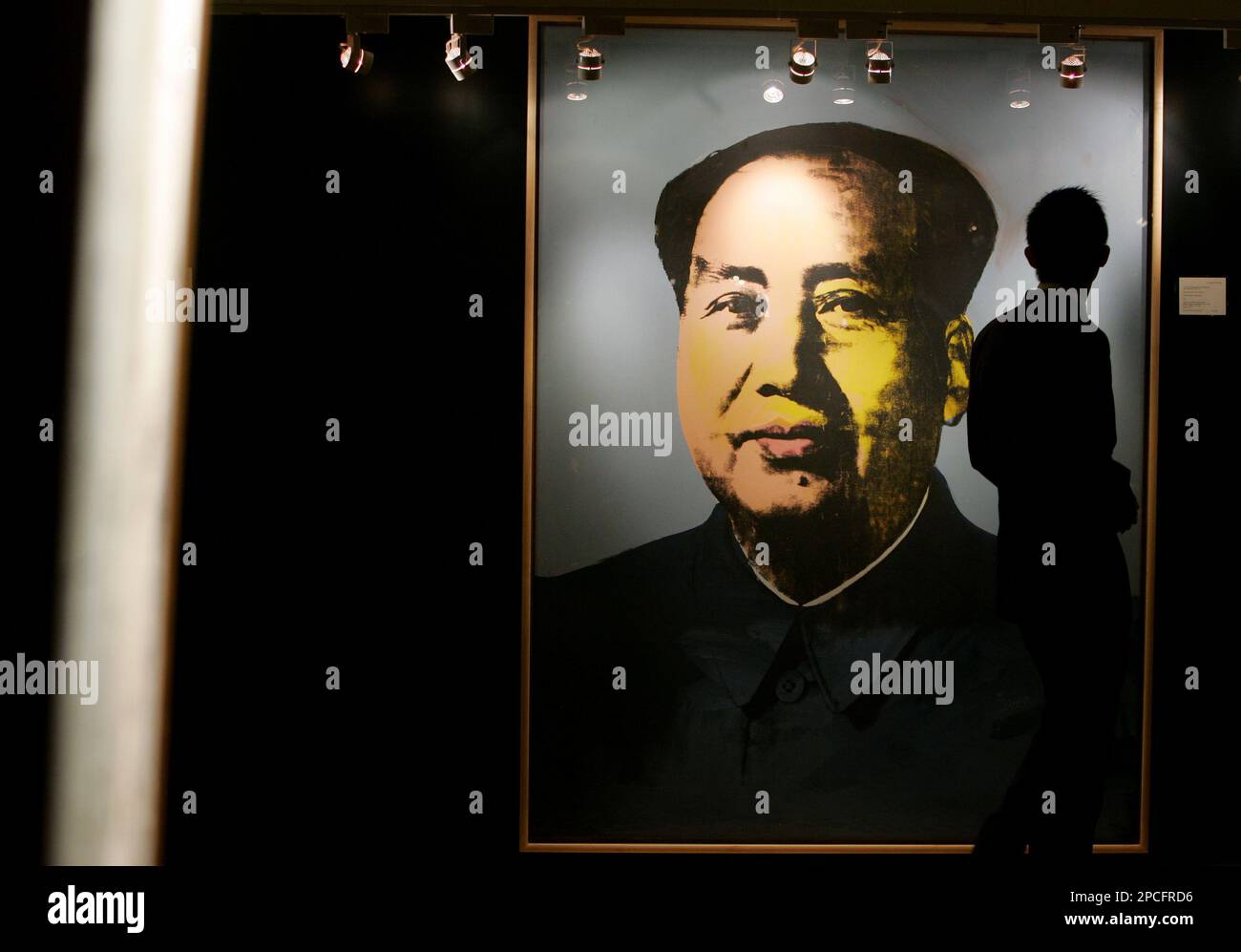 A staff from Christie's walks across the American pop artist Andy ...