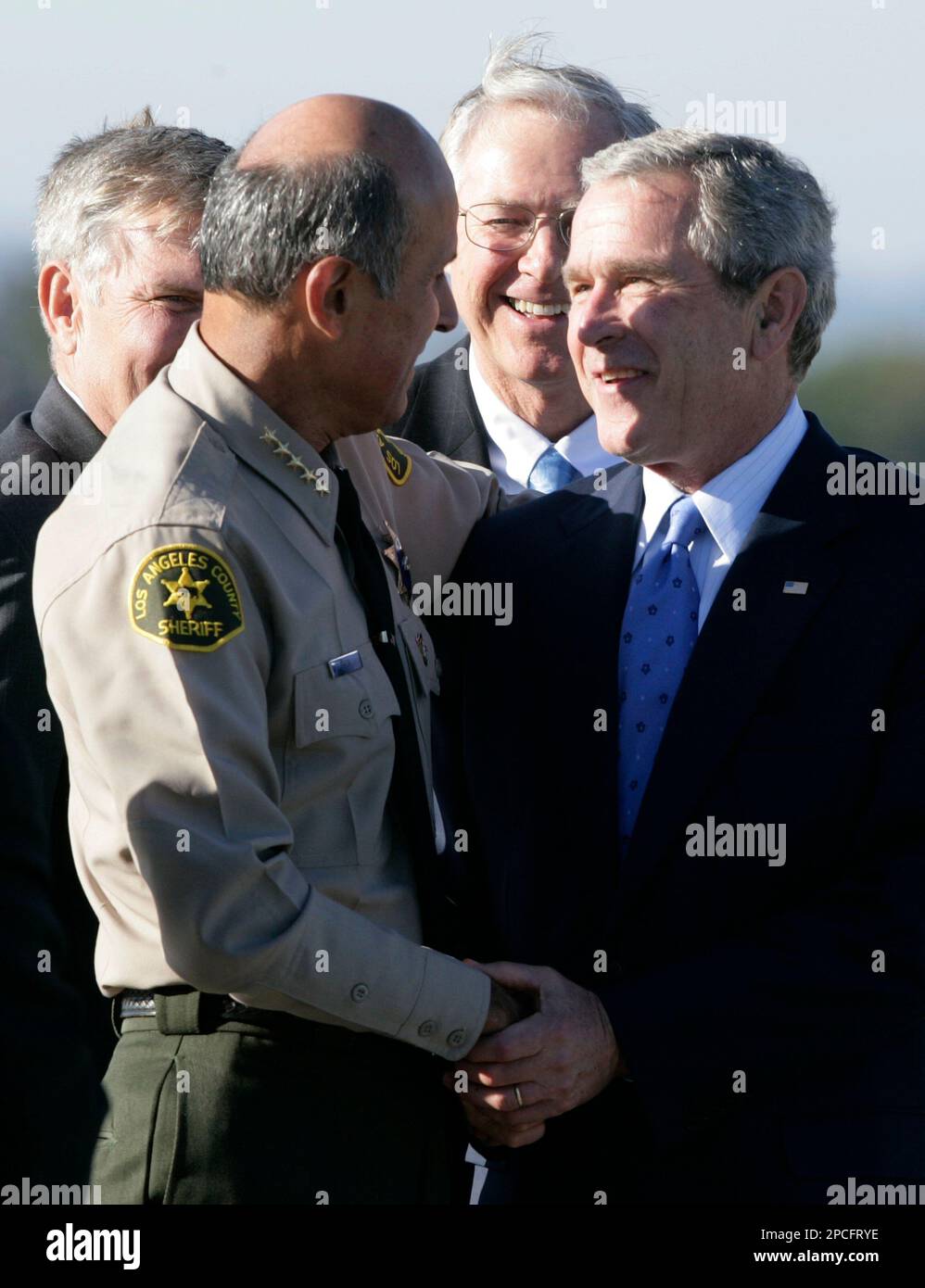 President Bush shakes hands with Los Angeles County Sheriff Lee Baca ...