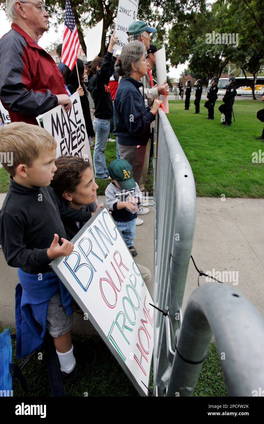 Cy Ustach, 4, holds an anti-war sign next to his mother, Colleen Ustach ...