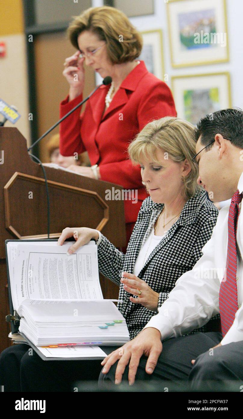 Laura Mallory, and husband Cole Mallory, right, look over case material ...