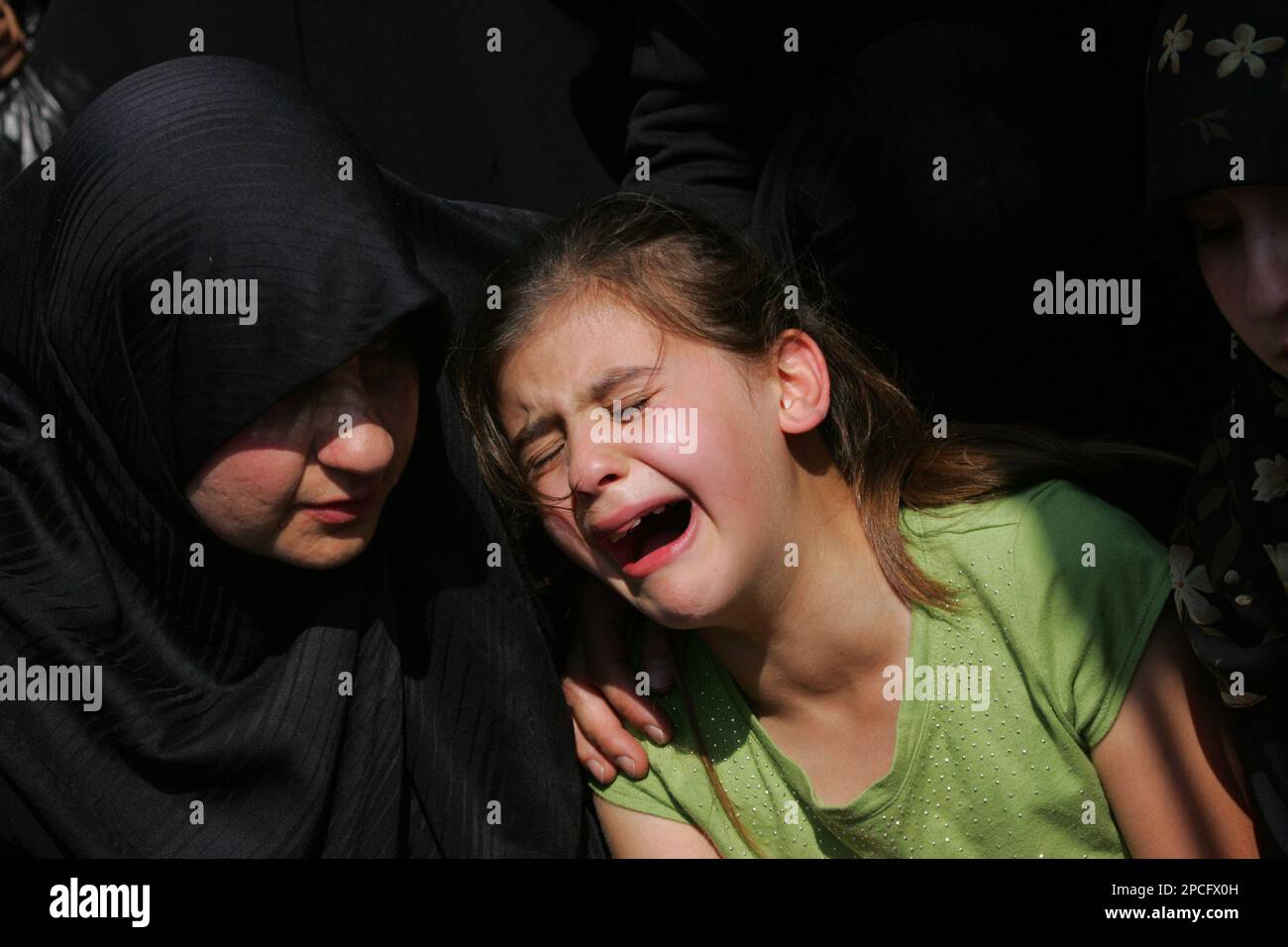 Seven-year-old Rima, right, cries as the body of her father, Lebanese ...