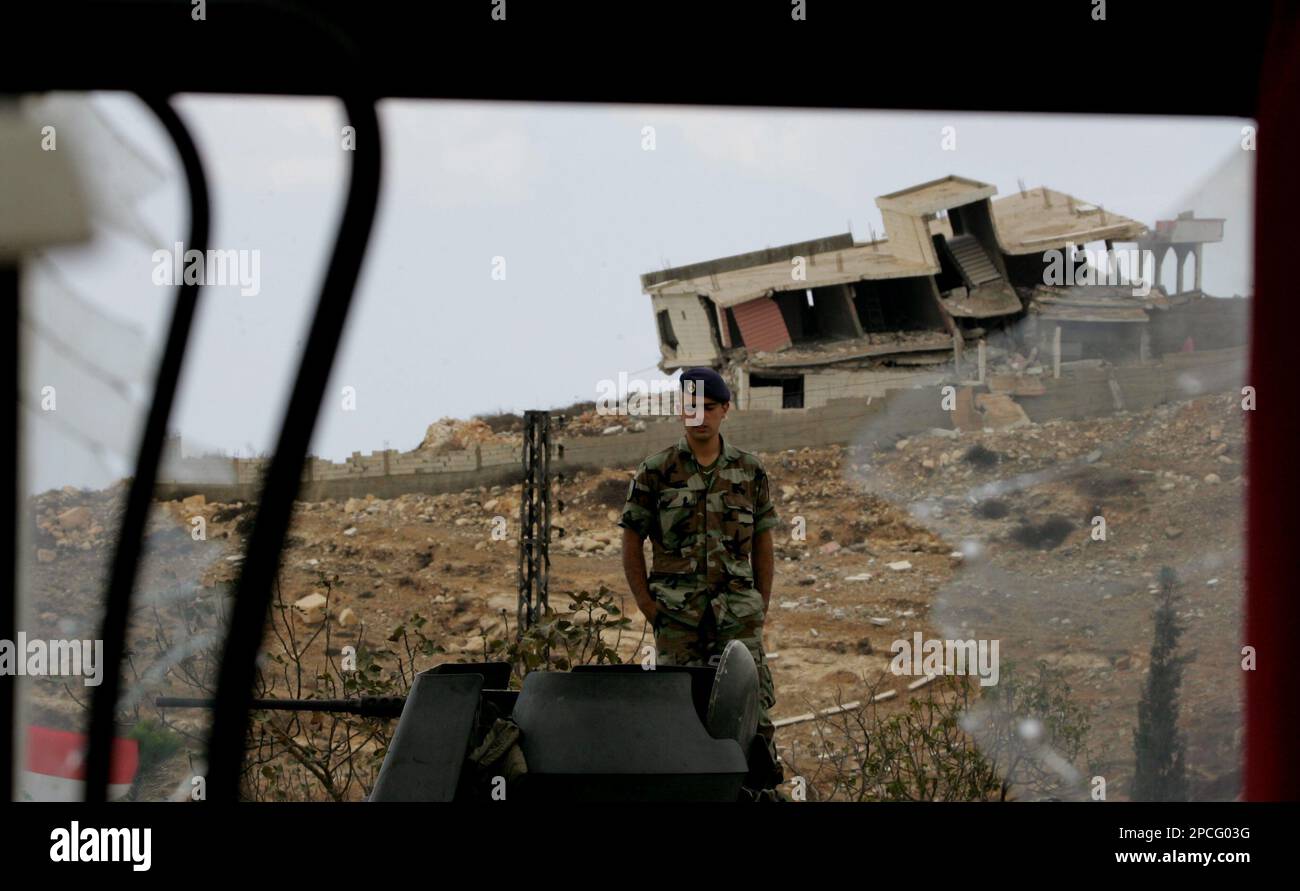 A Lebanese soldier stands atop his armoured personnel carrier is framed ...
