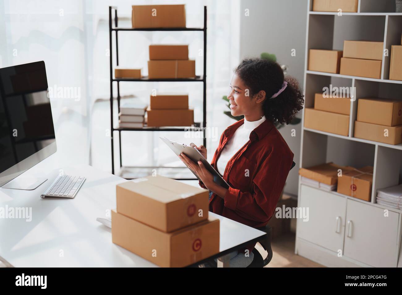 American African entrepreneur smile and checking online order ...