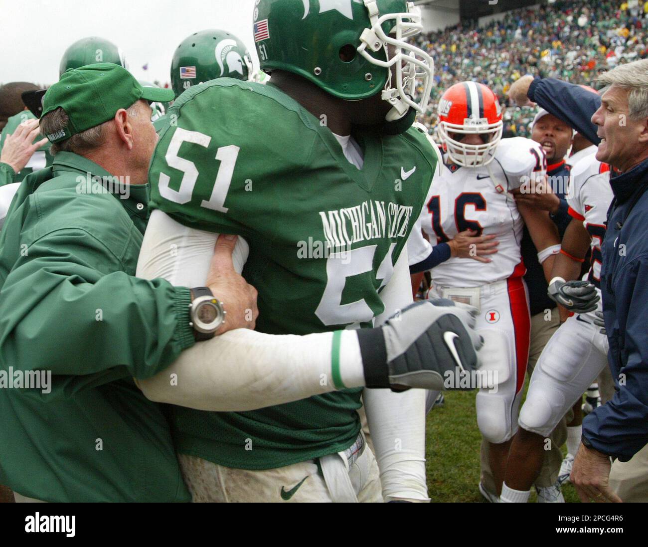 Michigan State coach John L. Smith, left, and Illinois coach Ron Zook ...