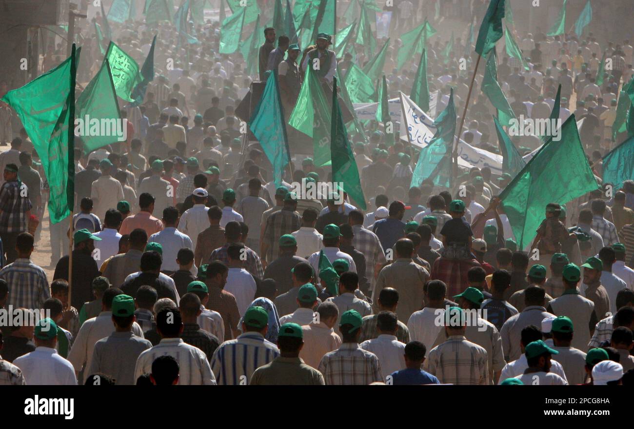 Palestinian Hamas supporters carry green Islamic flags during a rally ...