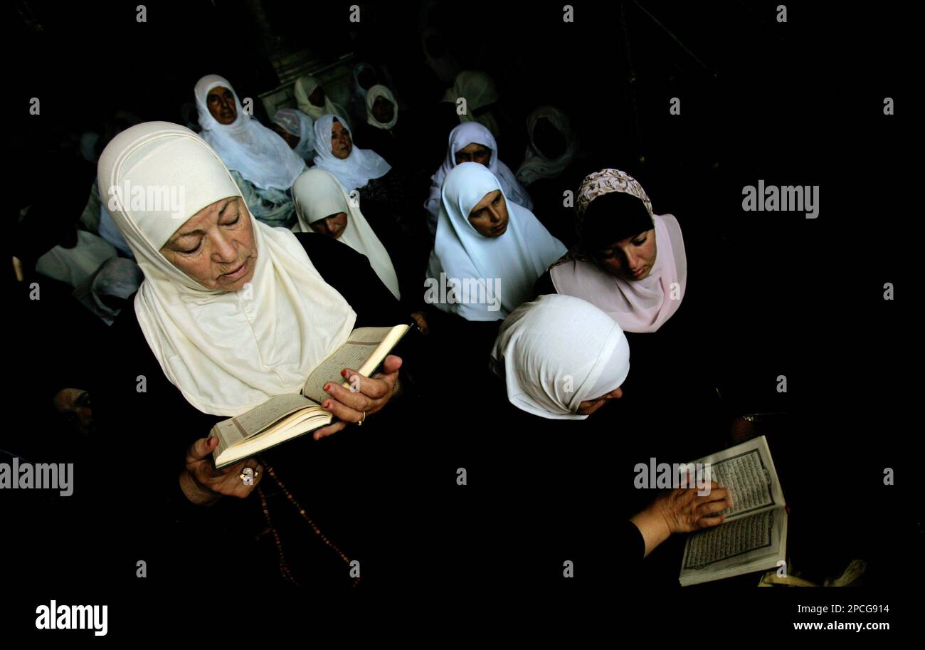 Female Muslim worshippers read the Quran, Islam's holy book, inside the ...