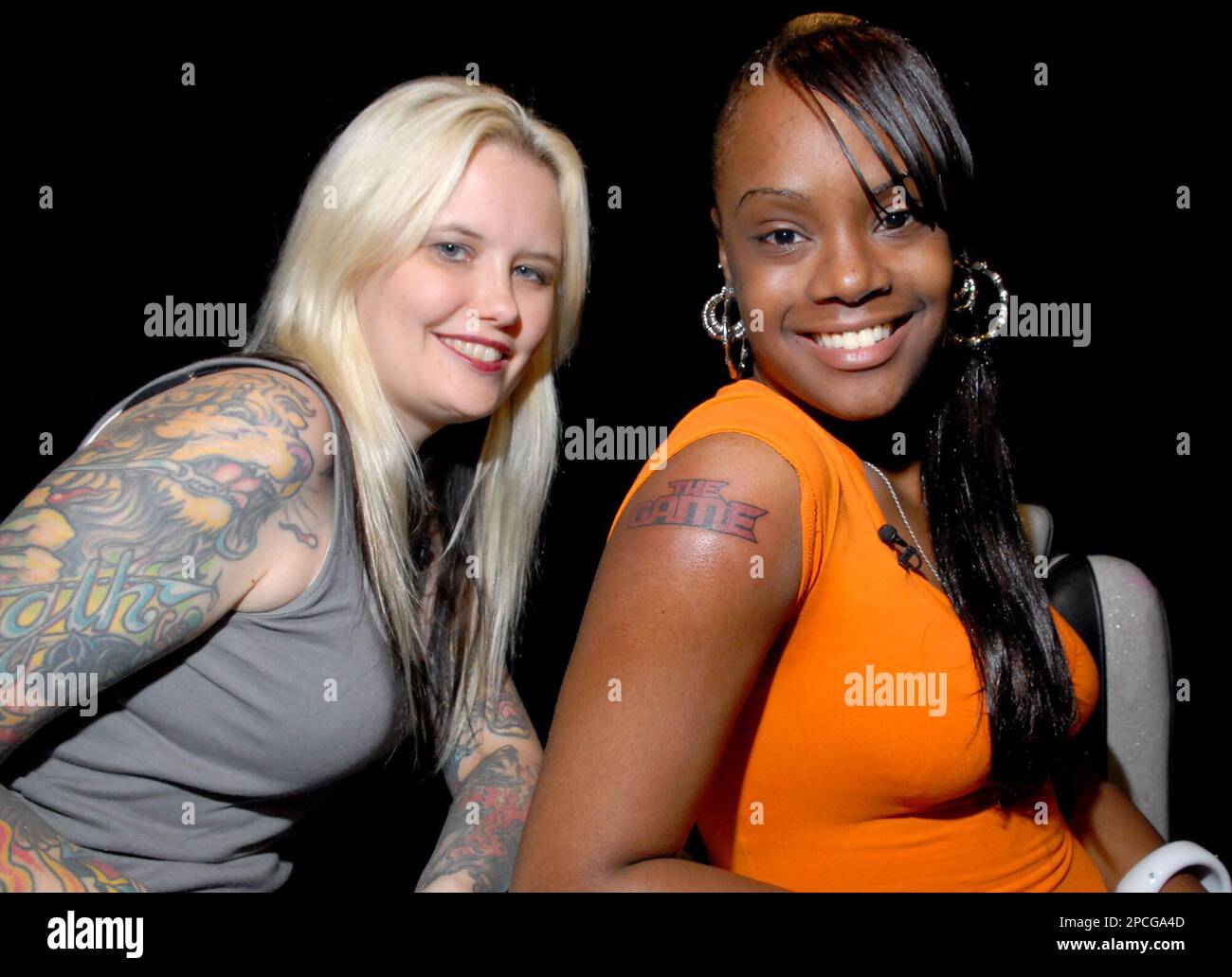 Tattoo artist Michelle Myles, left, poses with The Game fan Shakirah ...