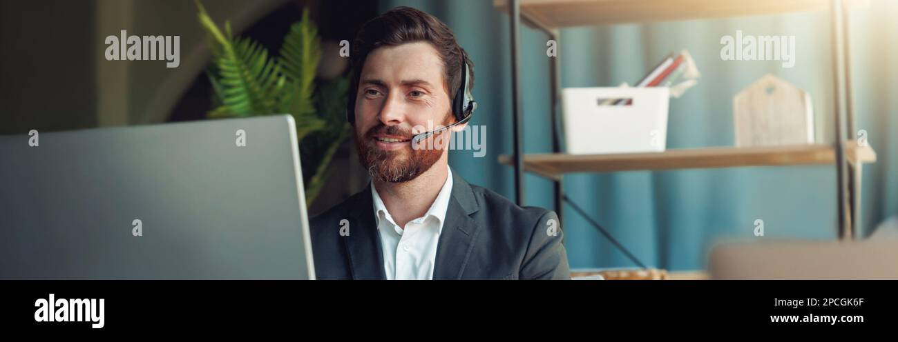 Male office worker sitting on his workplace while working computer ...