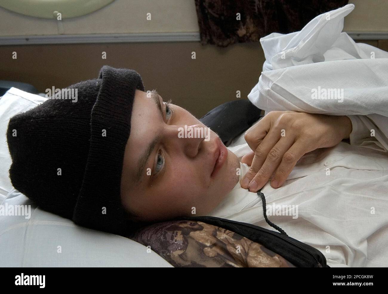 ** FILE ** Russian conscript Andrei Sychev, severely wounded in a military abuse incident, lies ...