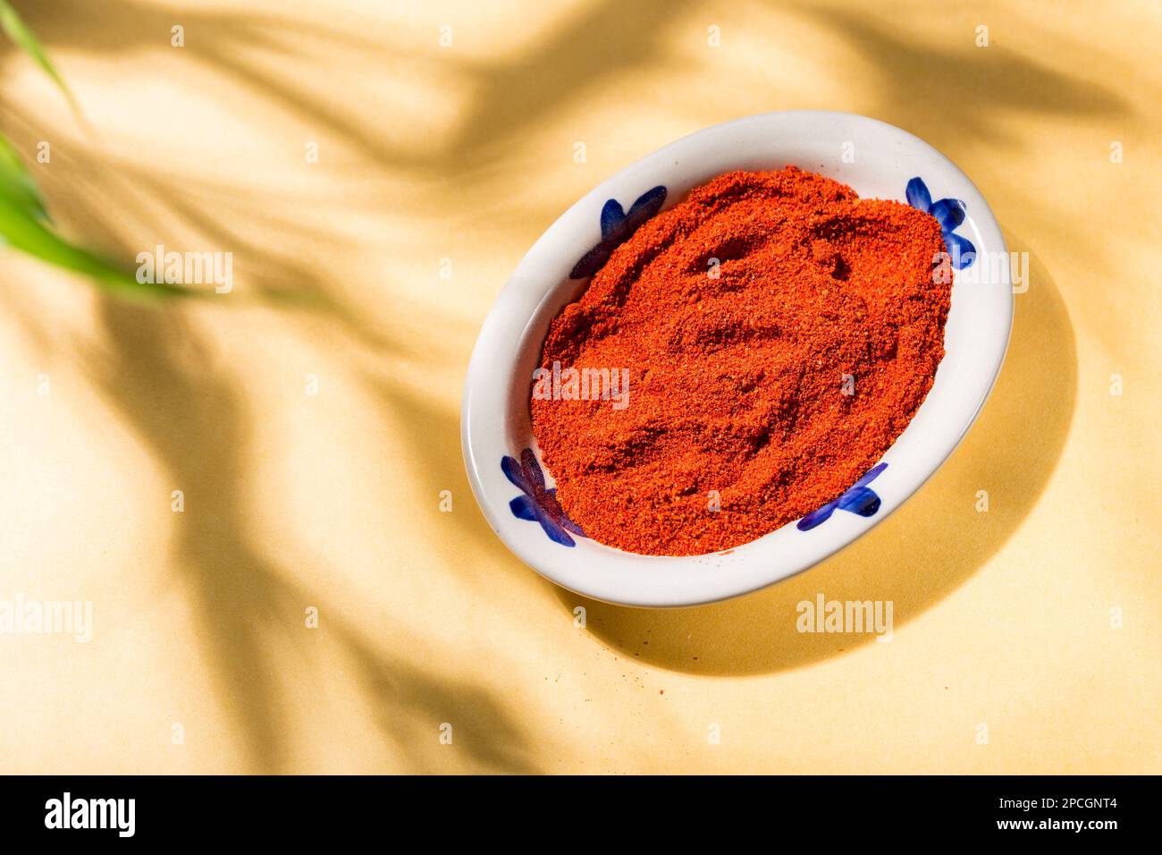 Tasty Spice: Paprika Powder in Ceramic Plate with Yellow Background and ...