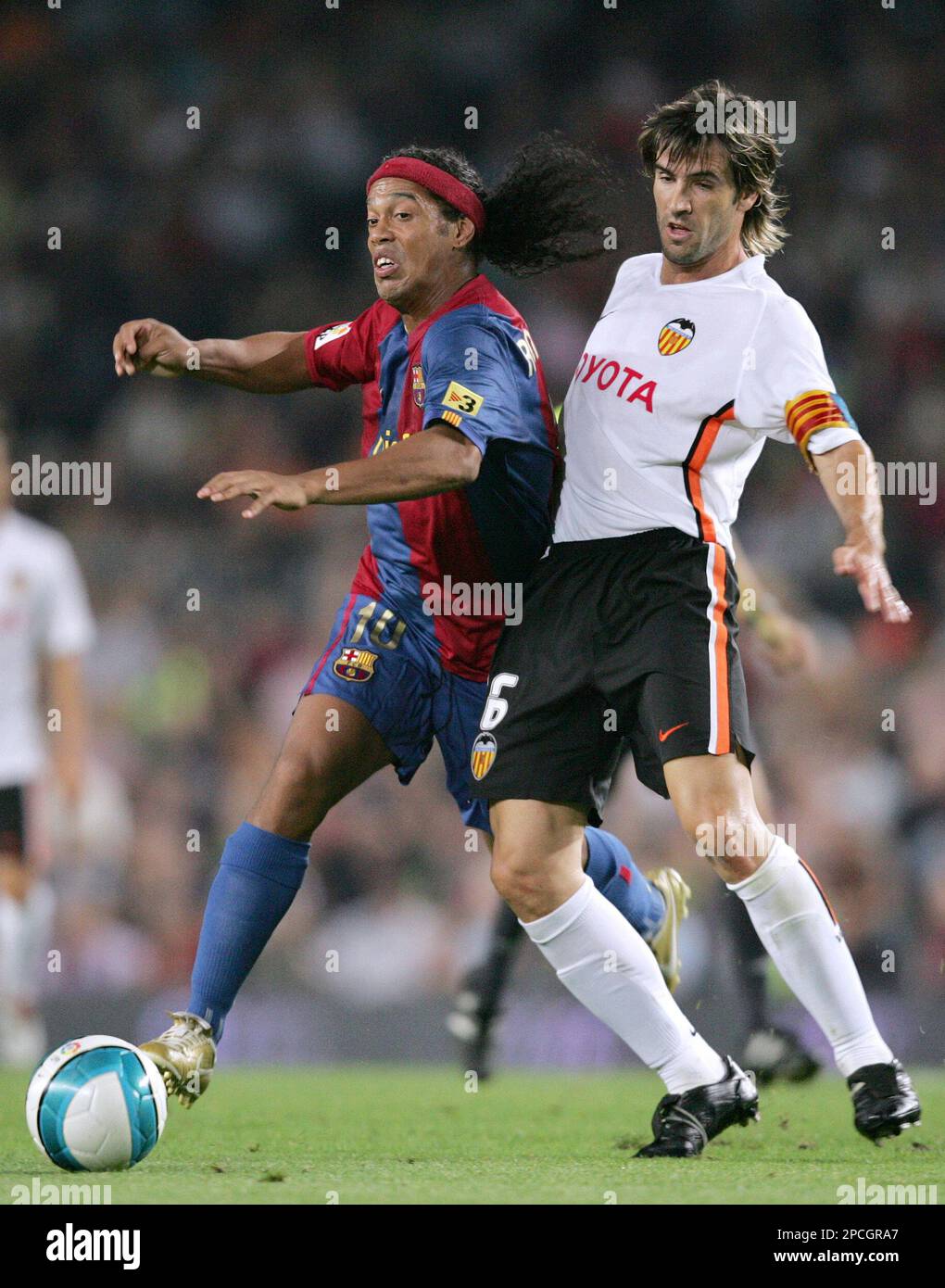 FC Barcelona player Ronaldinho, from Brazil, left, duels for the ball ...