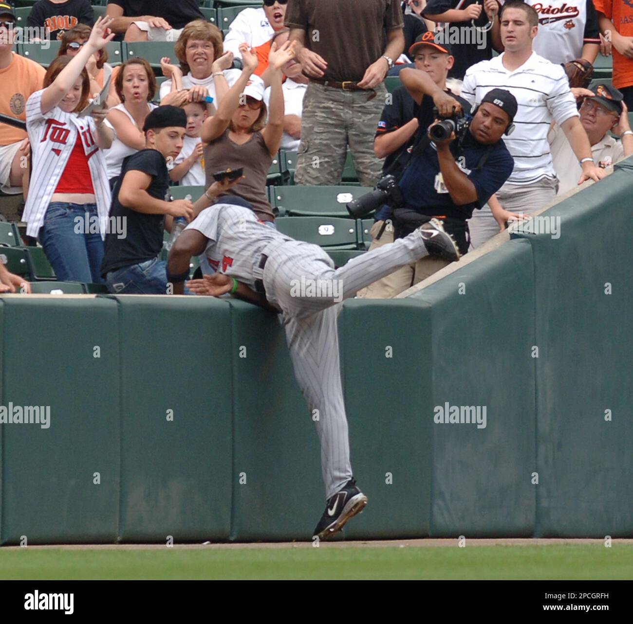 Minnesota Twins leftfielder Rondell White goes into the crowd to catch ...