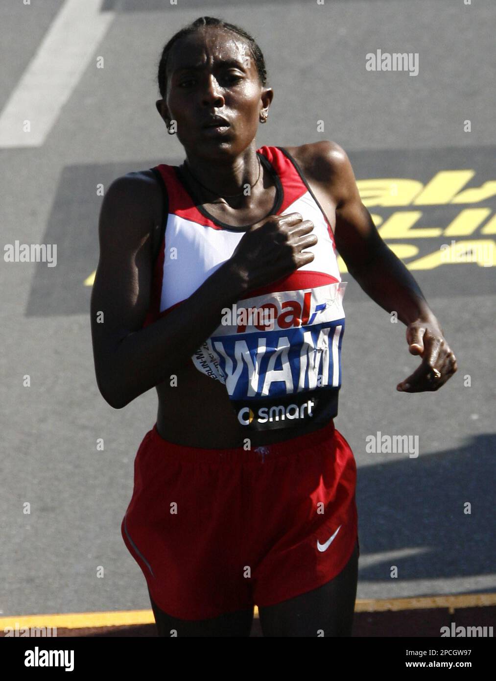 Gete Wami from Ethiopia crosses the finish line to win the women's ...