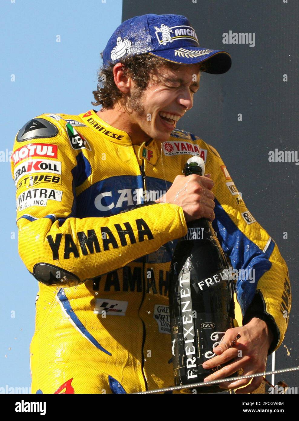 Italy's MotoGP rider Valentino Rossi holds a champagne bottle during ...