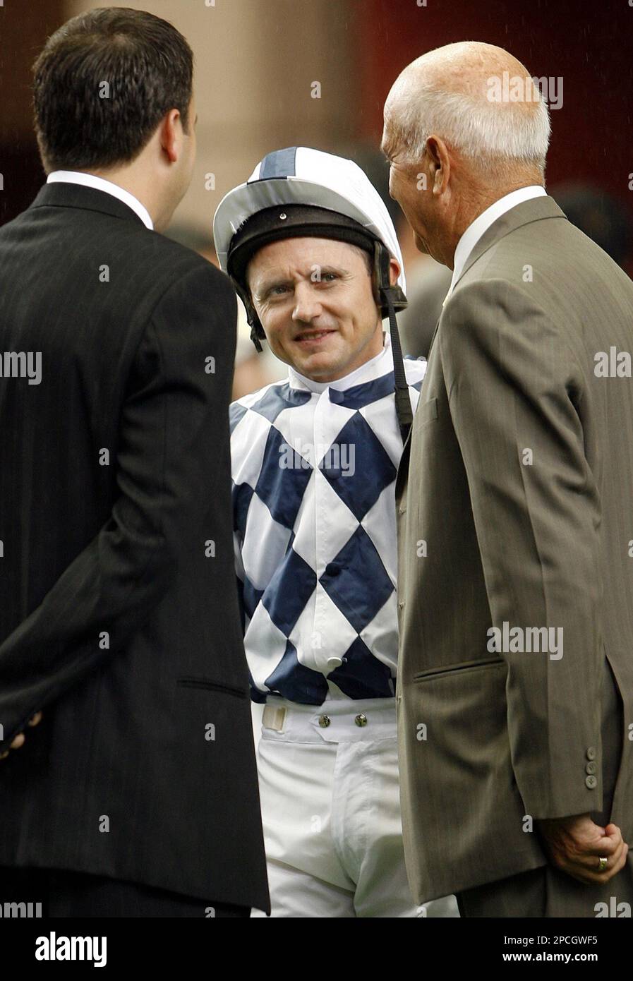 New Zealand-born Australian jockey Shane Dye, center, shares a light ...