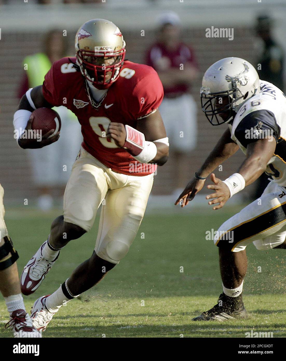 Florida State quarterback Xavier Lee, left, runs for third-quarter ...