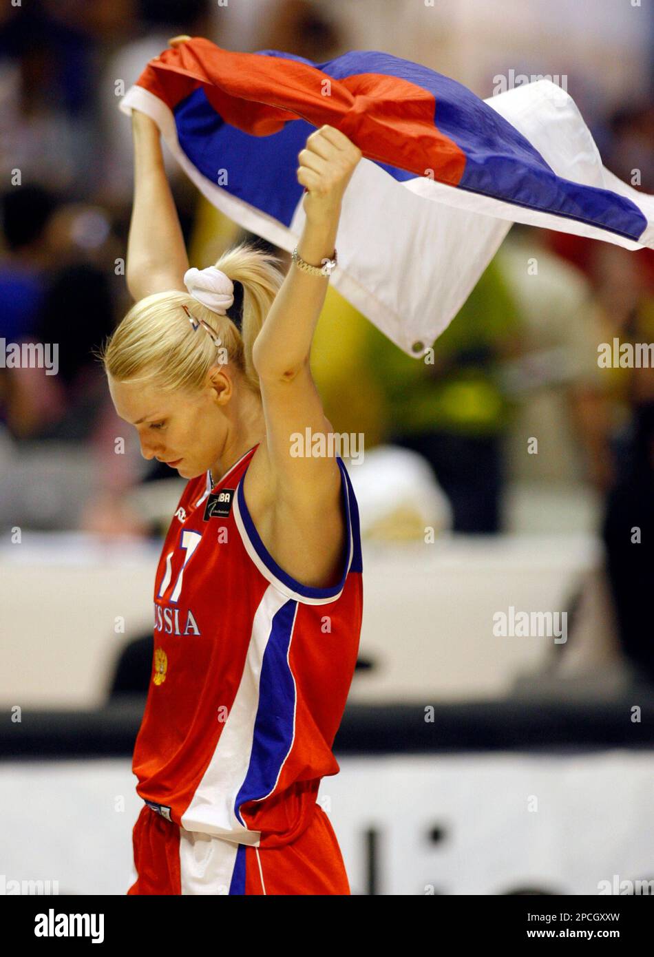 Russia's Maria Stepanova exits the basketball court waving a Russian flag after being defeated ...