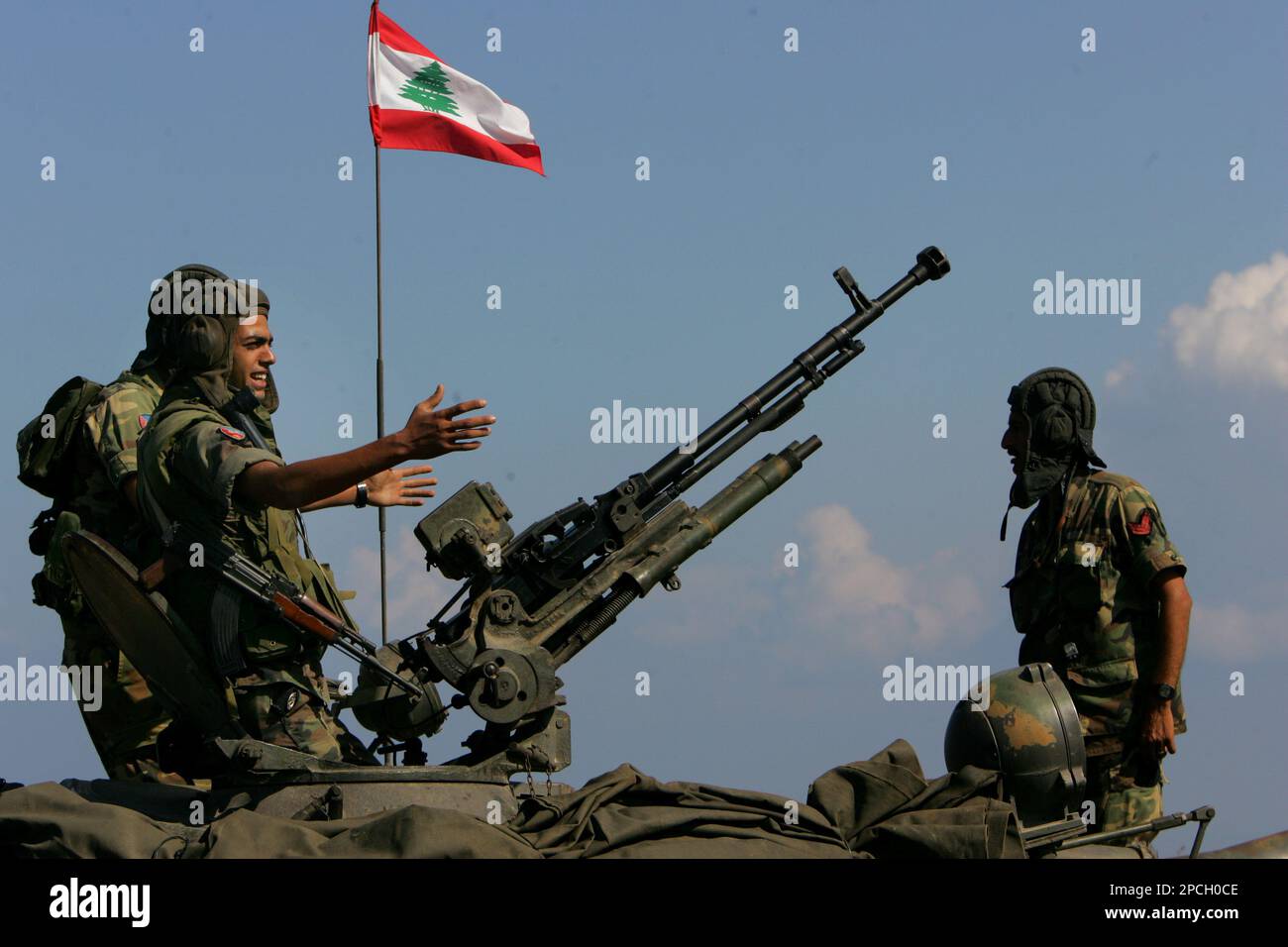 A Lebanese soldier gestures as the tank crew takes up positions half a ...